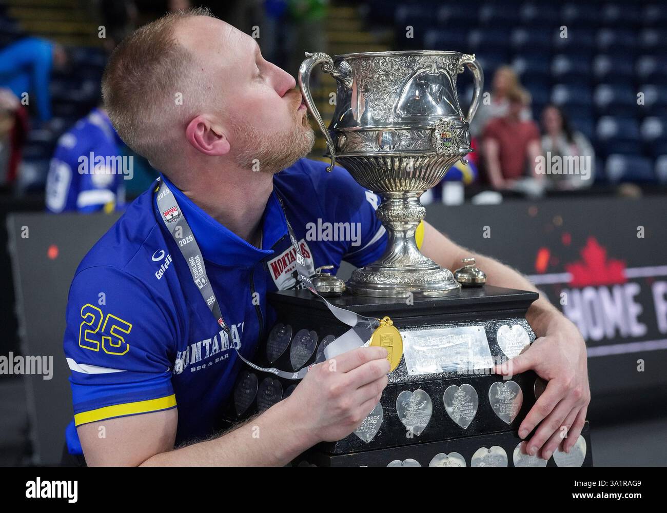 Alberta-Jacobs skip Brad Jacobs kisses the Brier tankard while posing for photos after defeating ...