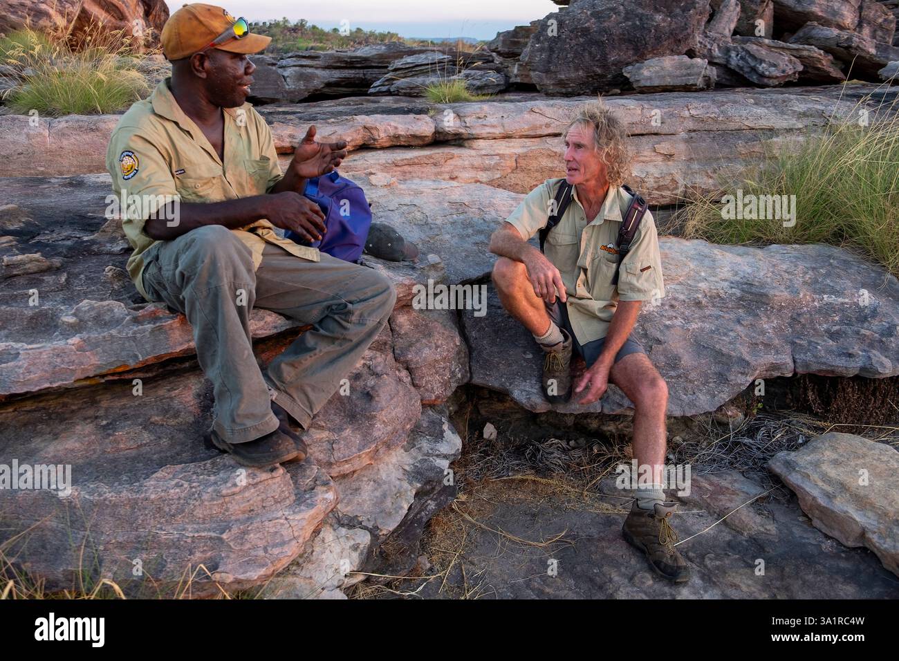 An Indigenous ranger tour guide exchanging stories with white tour ...