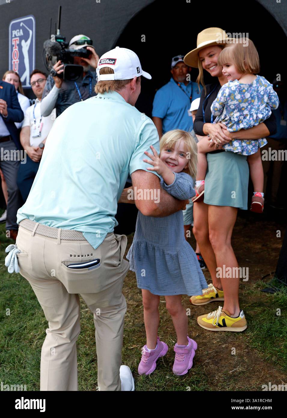 ORLANDO, FL - MARCH 09: PGA golfer Russell Henley picks up his daughter ...