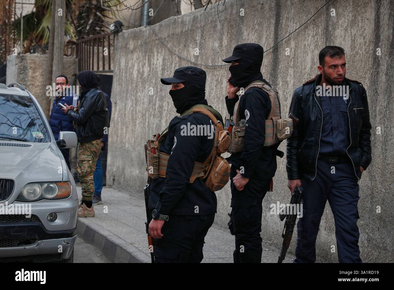 Syrian government security forces stand near a police station in the ...