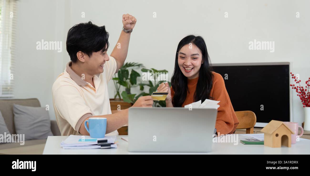 Successful financial planning. Young couple celebrating their financial ...
