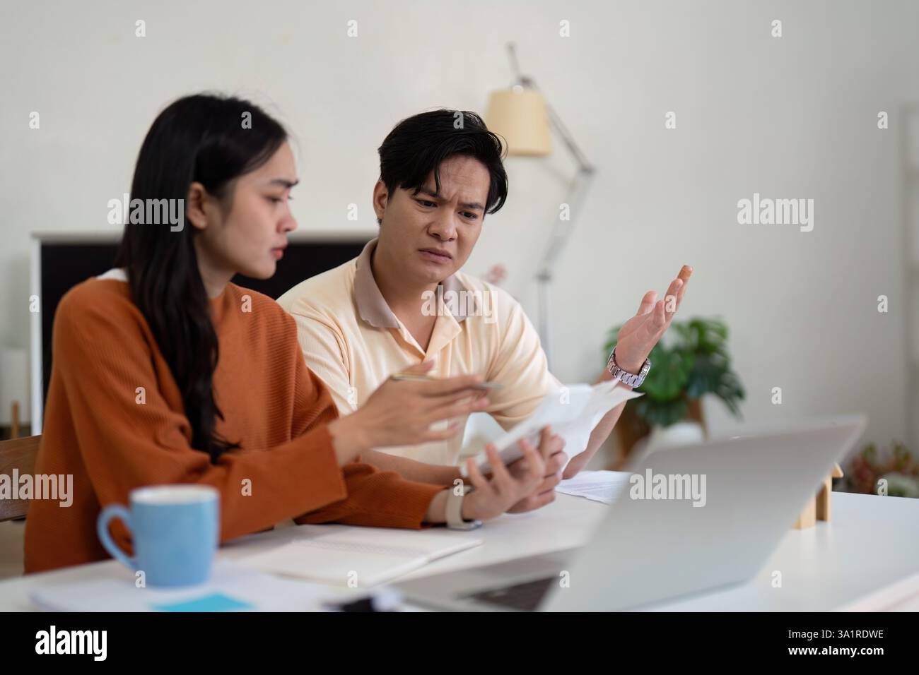 Couples' financial discussion. Couple analyzing their finances together ...