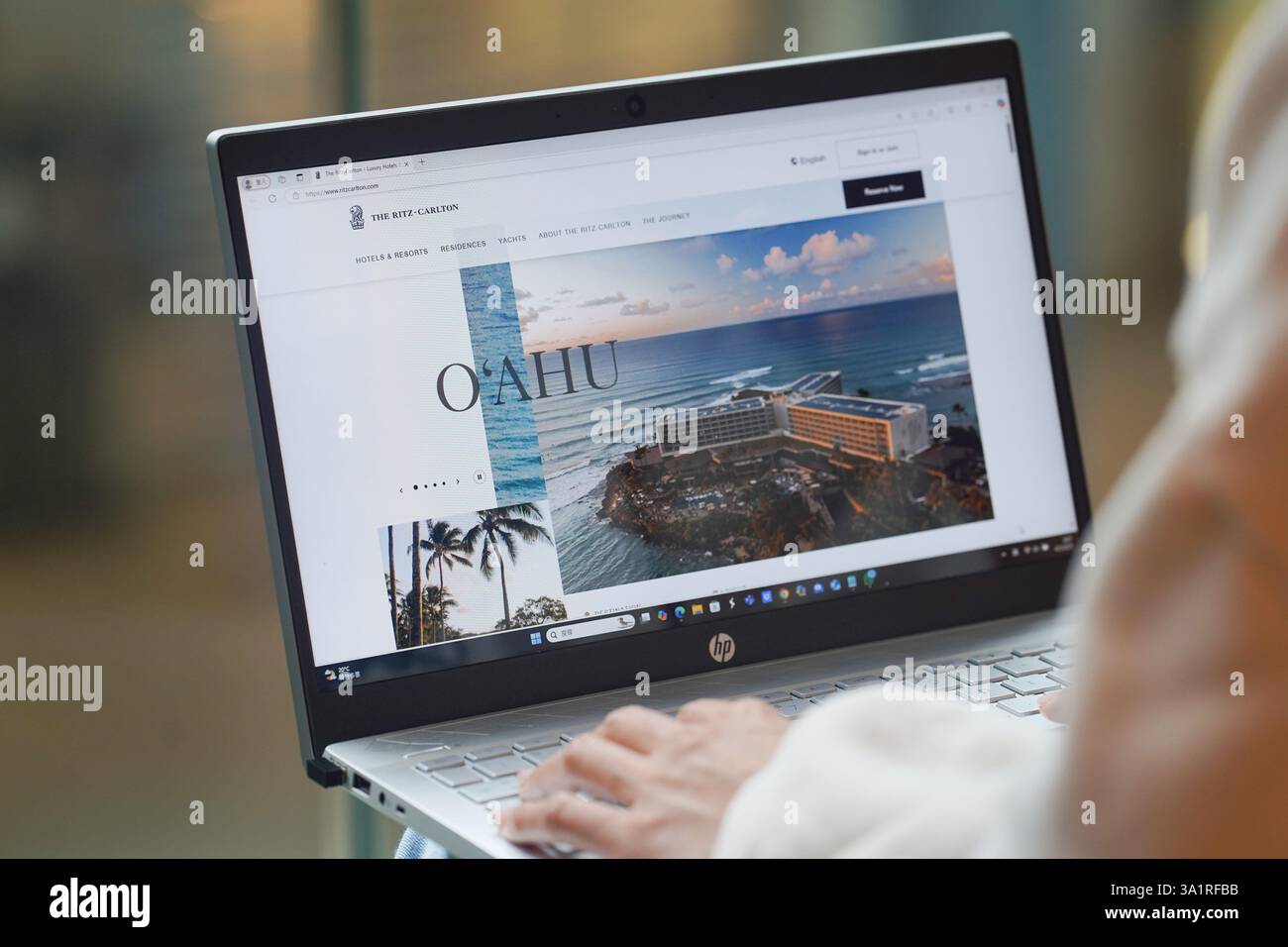 In this photo illustration, A woman browses Ritz-Carlton website on her ...