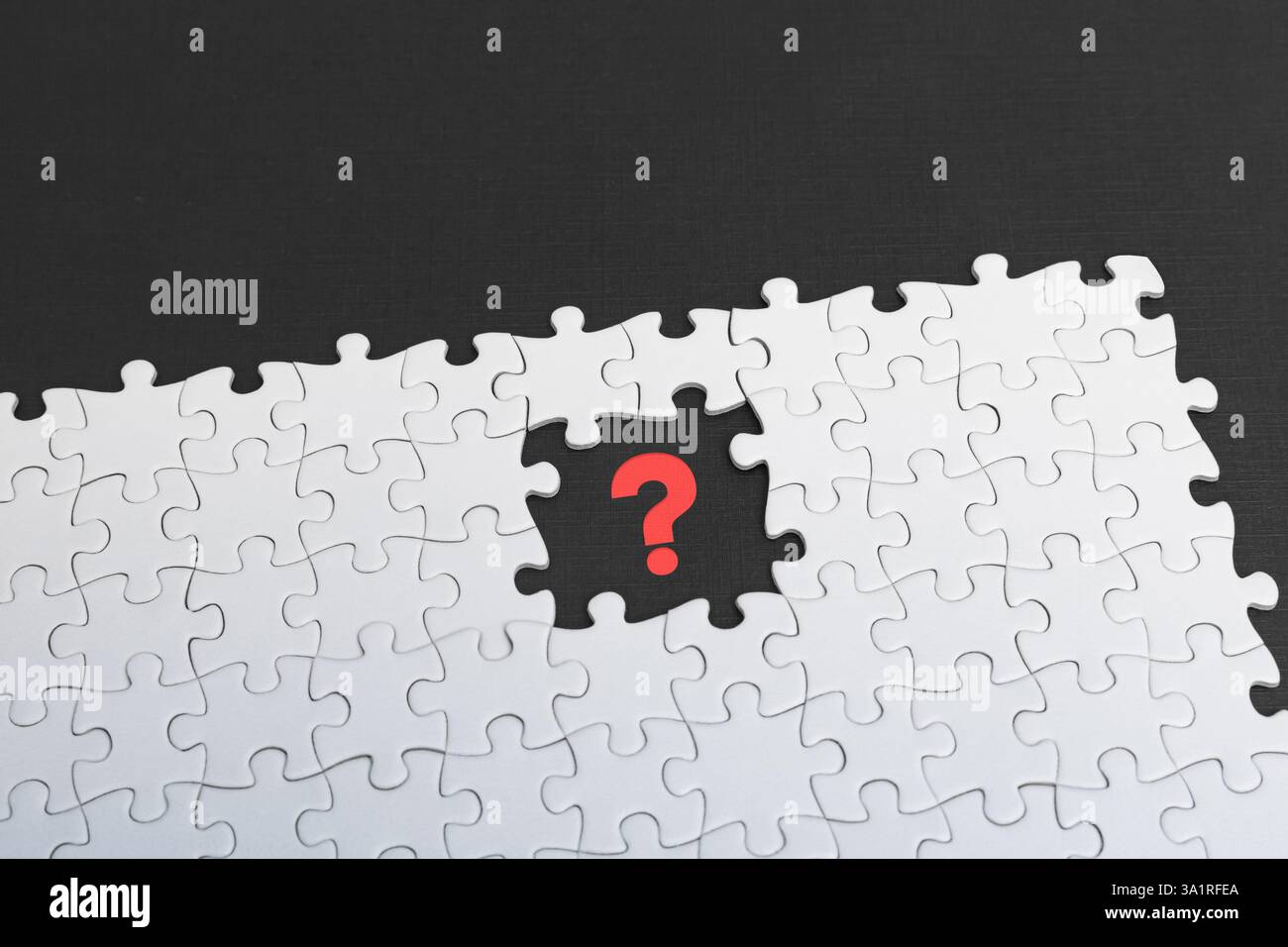 An incomplete jigsaw puzzle with a distinct absence of a red question ...