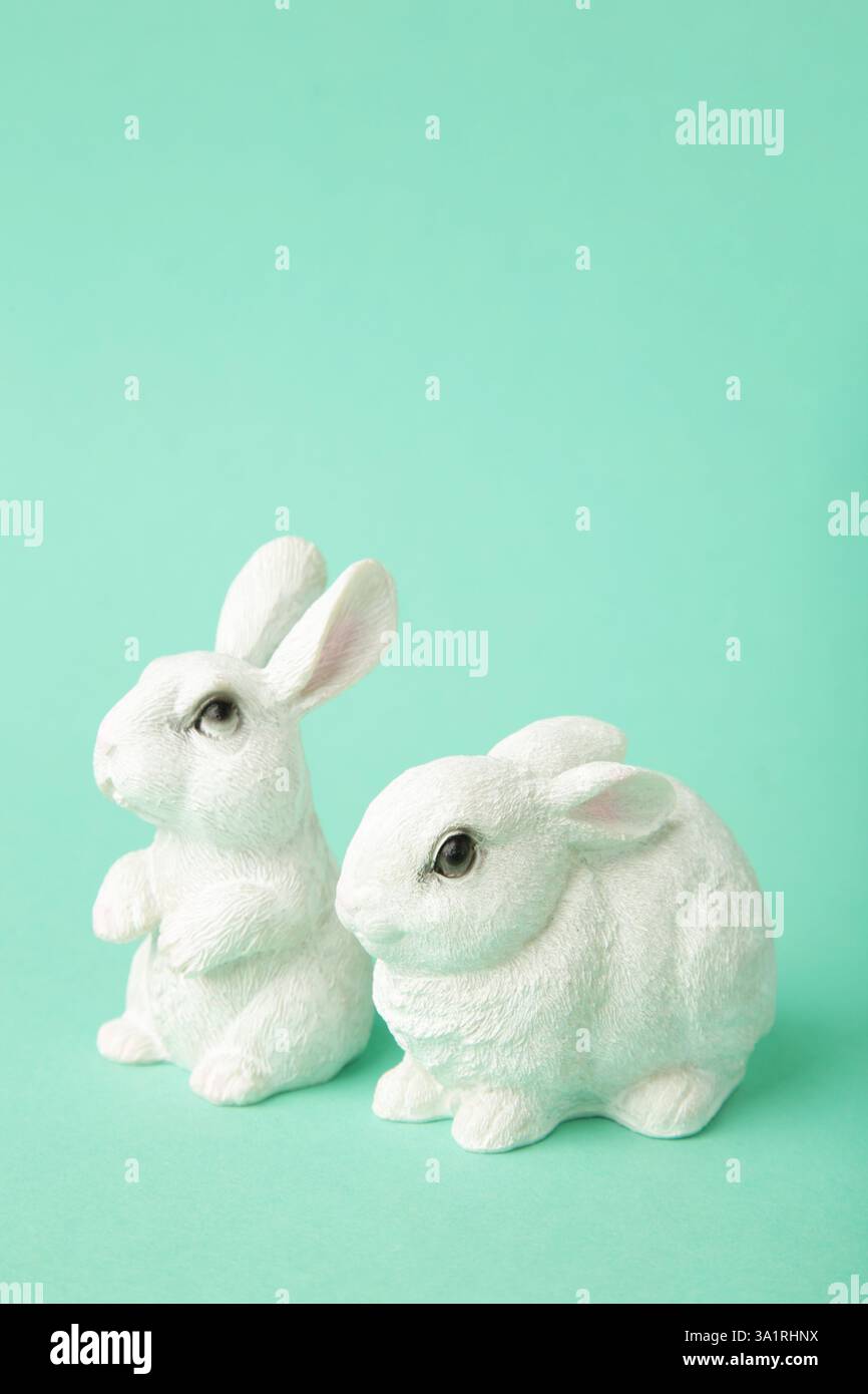 White ceramic rabbits on mint background. Top view Stock Photo - Alamy