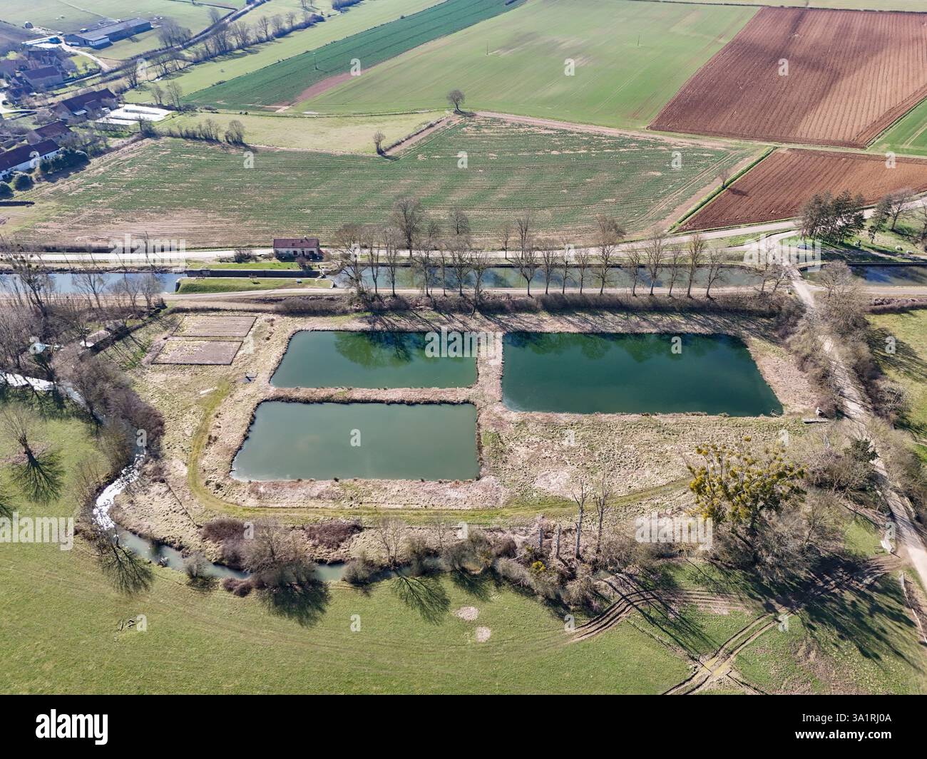 Aerial view of the Burgundy canal with a lock and water basins in ...