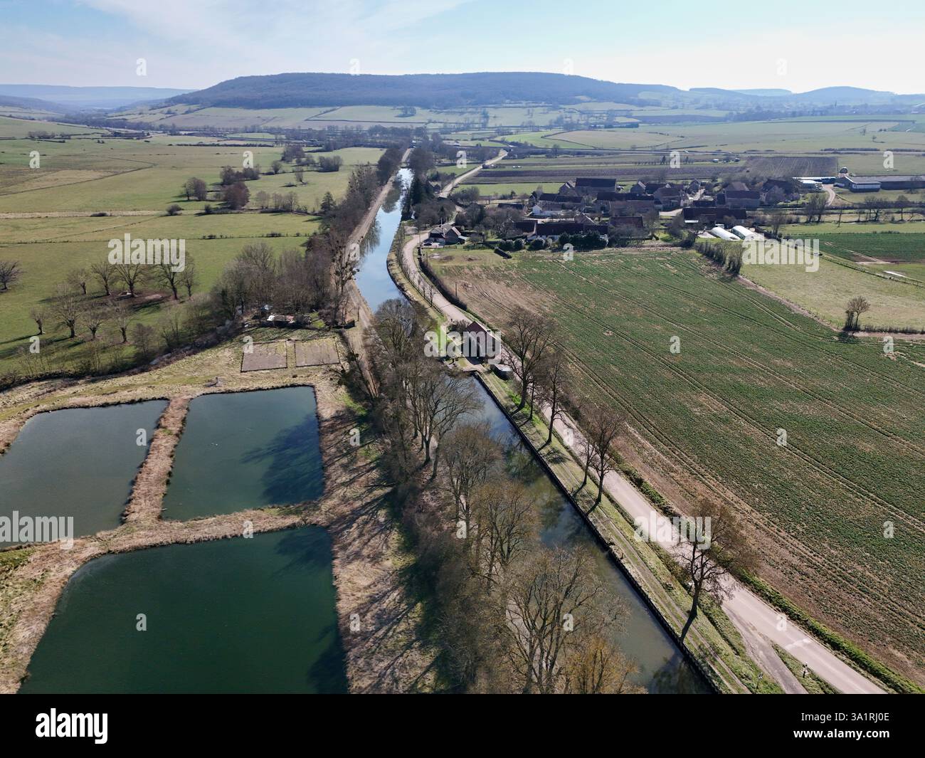 Aerial view of the Burgundy canal with a lock and water basins in ...