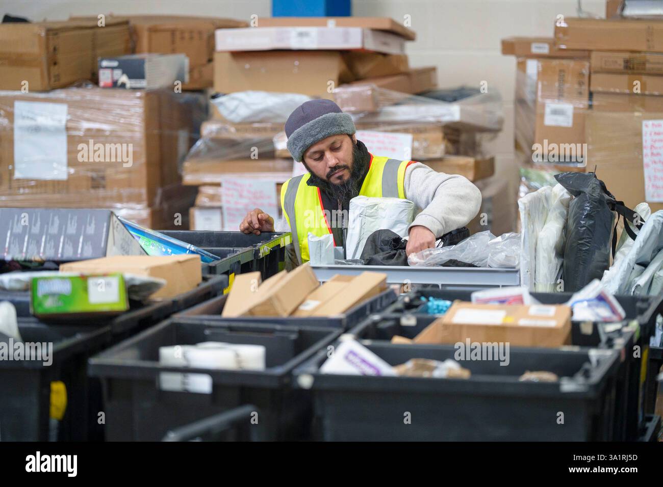EDITORIAL USE ONLY Sabbir Ahmed Sumon packs goods at the new West Midlands Multibank in ...
