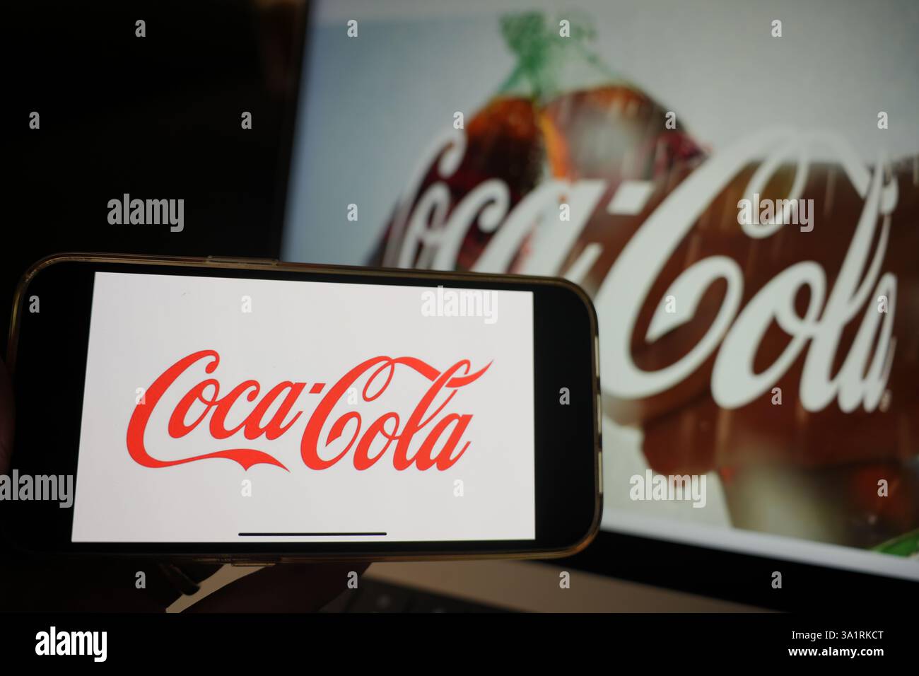 Roosendaal, The Netherlands - March 10, 2025: A mobile phone displaying the logo of Coca-Cola ...