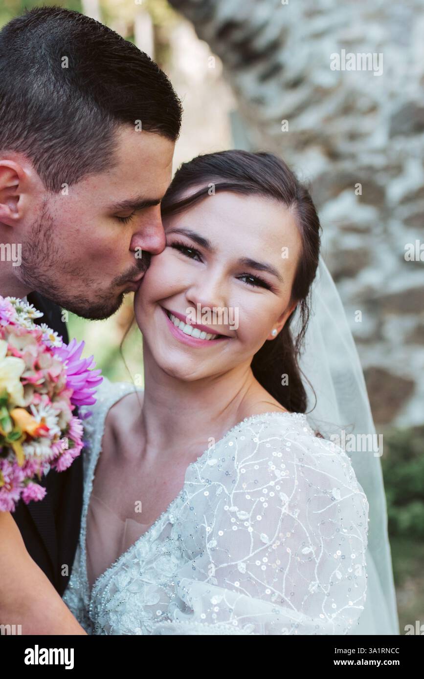 Bride kissing cheek groom hi-res stock photography and images - Alamy