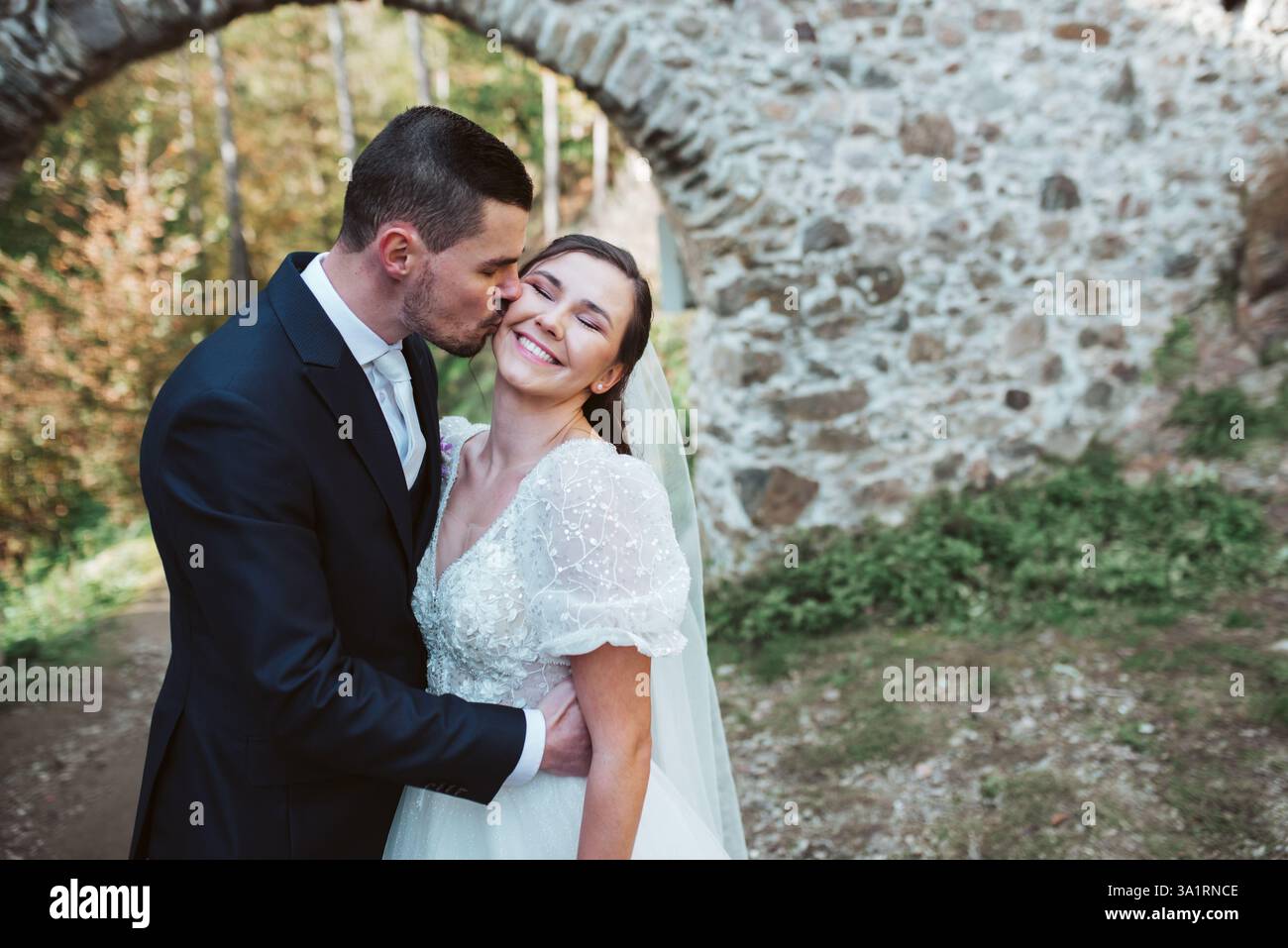 Bride kissing cheek groom hi-res stock photography and images - Alamy