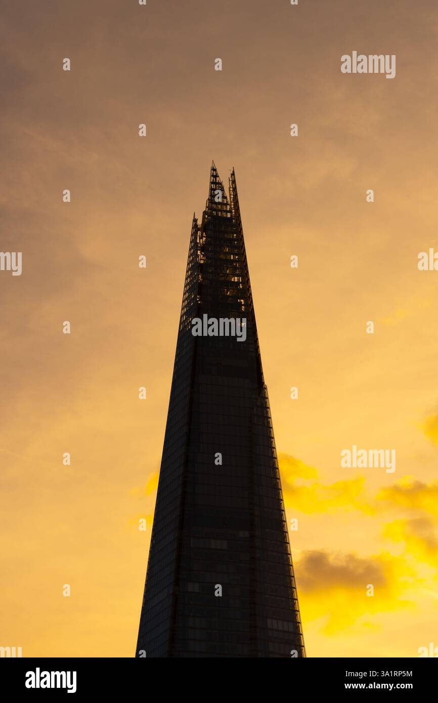 The Shard skyscraper stands tall against a vibrant sunset in London ...
