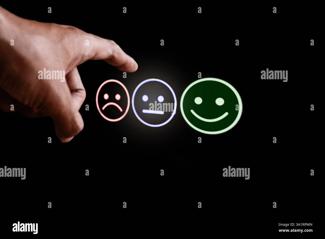A person's finger hovers above a glowing face emoticon. Emotion ...
