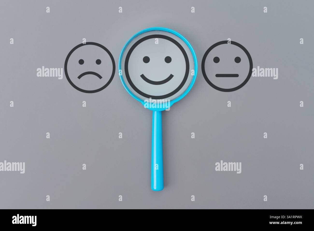 A blue magnifying glass with a happy face emoticon visible through the ...