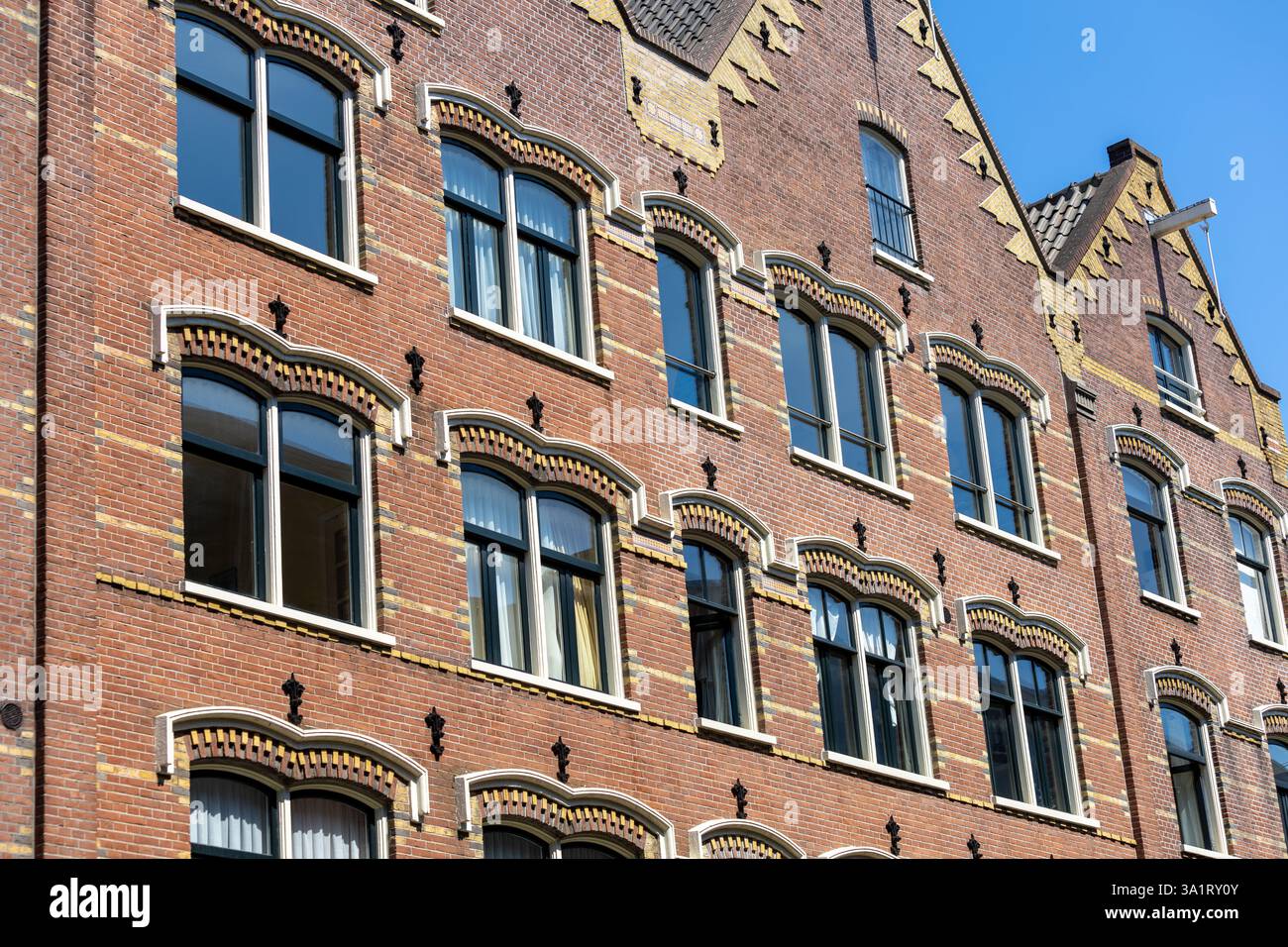 Facades of buildings in Amsterdam, historical canal brick houses in a ...