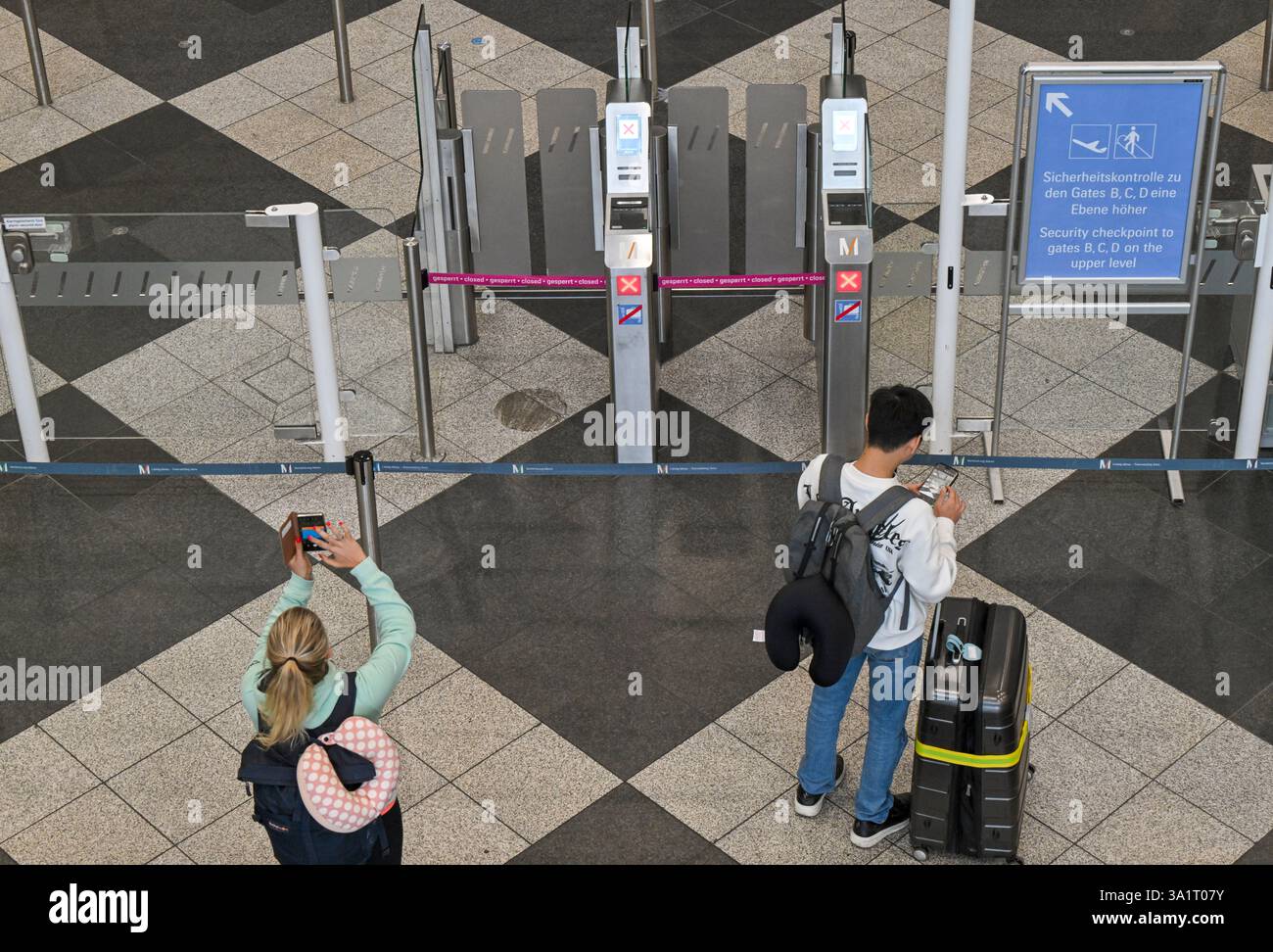 Munich, Germany. 10th Mar, 2025. Passengers photograph the entrance ...