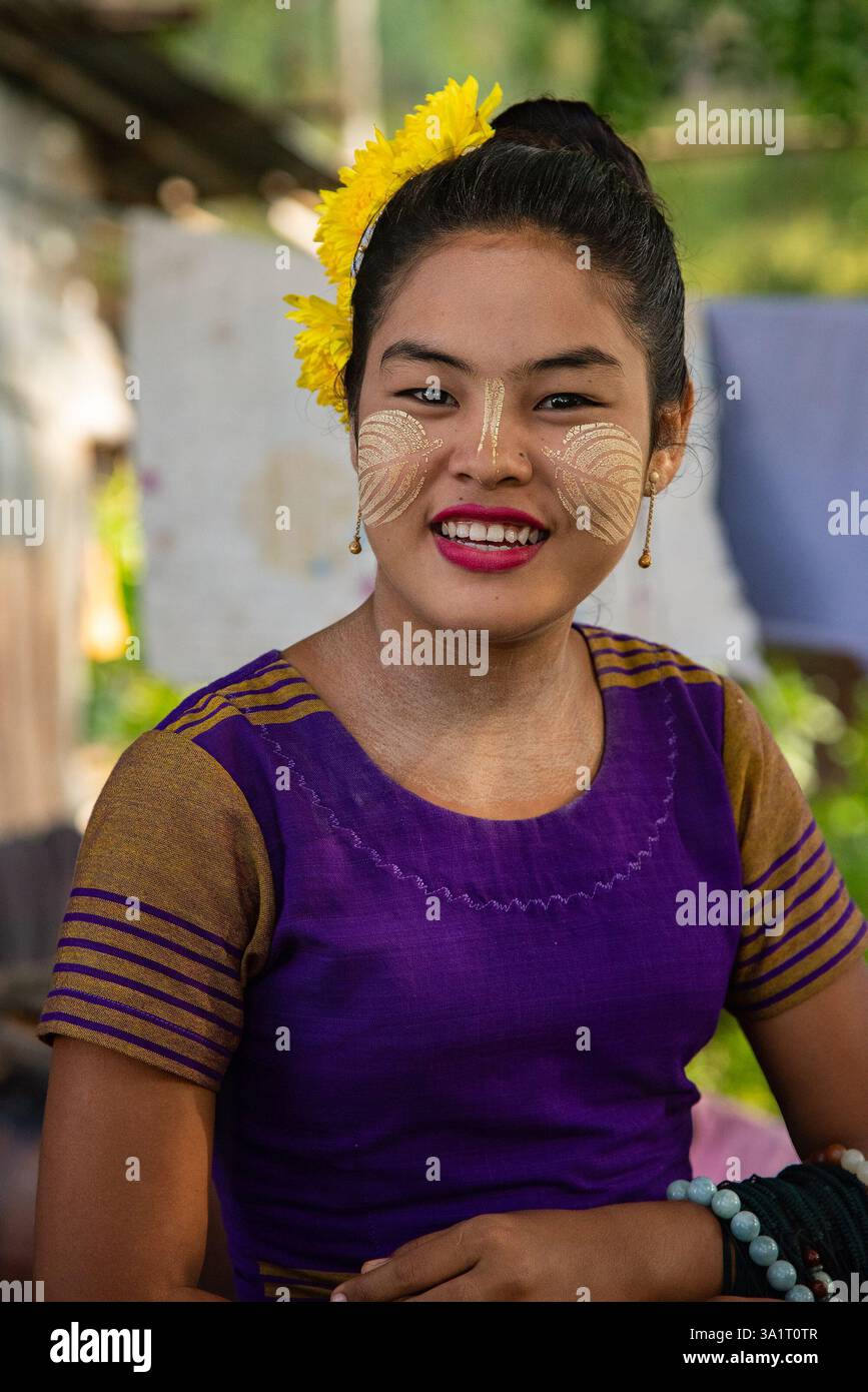 Portrait of a young woman selling souvenirs to tourists in Inwa ...