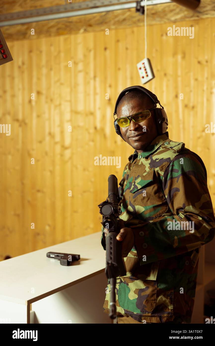 Portrait of smiling man at shooting range used to train and test ...