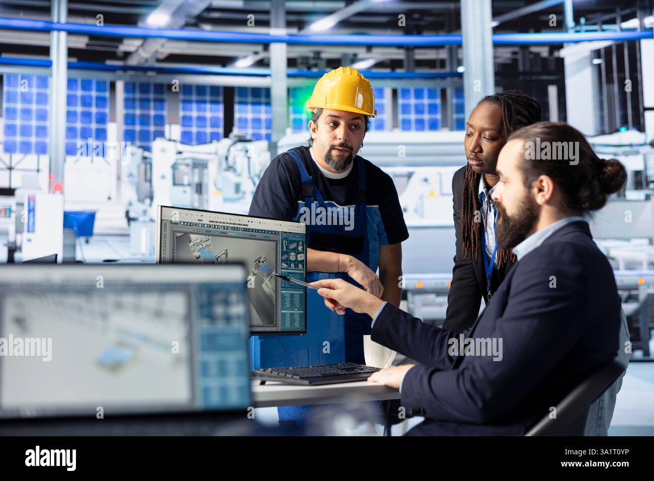 Photovoltaics factory manager checking work done by employees to ...