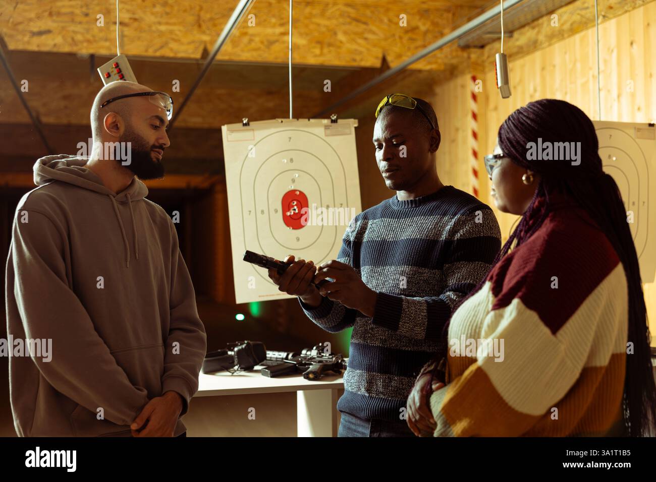 Shooting range safety expert ensuring clients are operating weapons ...