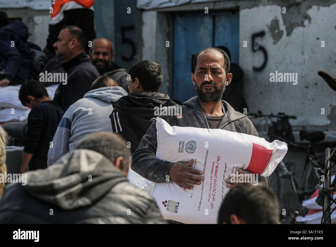 Gaza. 9th Mar, 2025. Palestinians receive wheat flour packages as ...