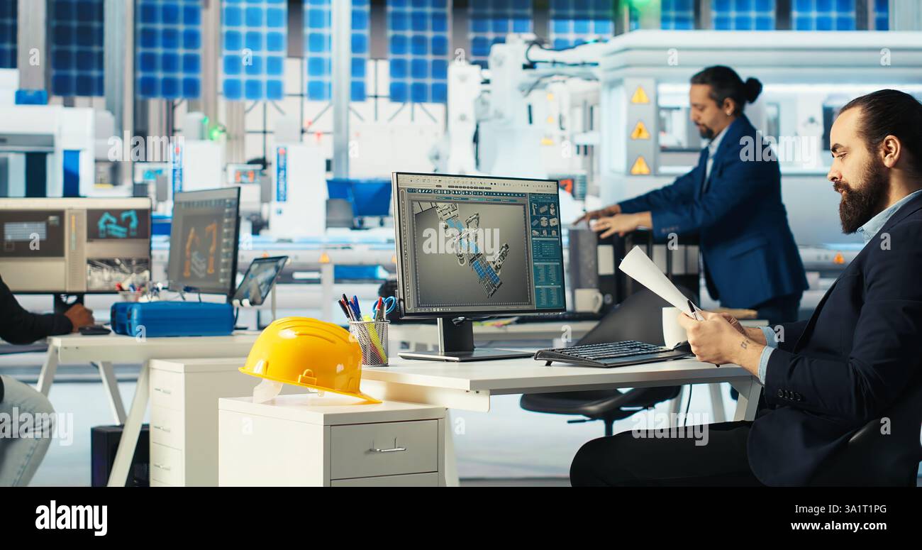 Photovoltaics factory manager looking over paperwork documents, monitoring system performance ...