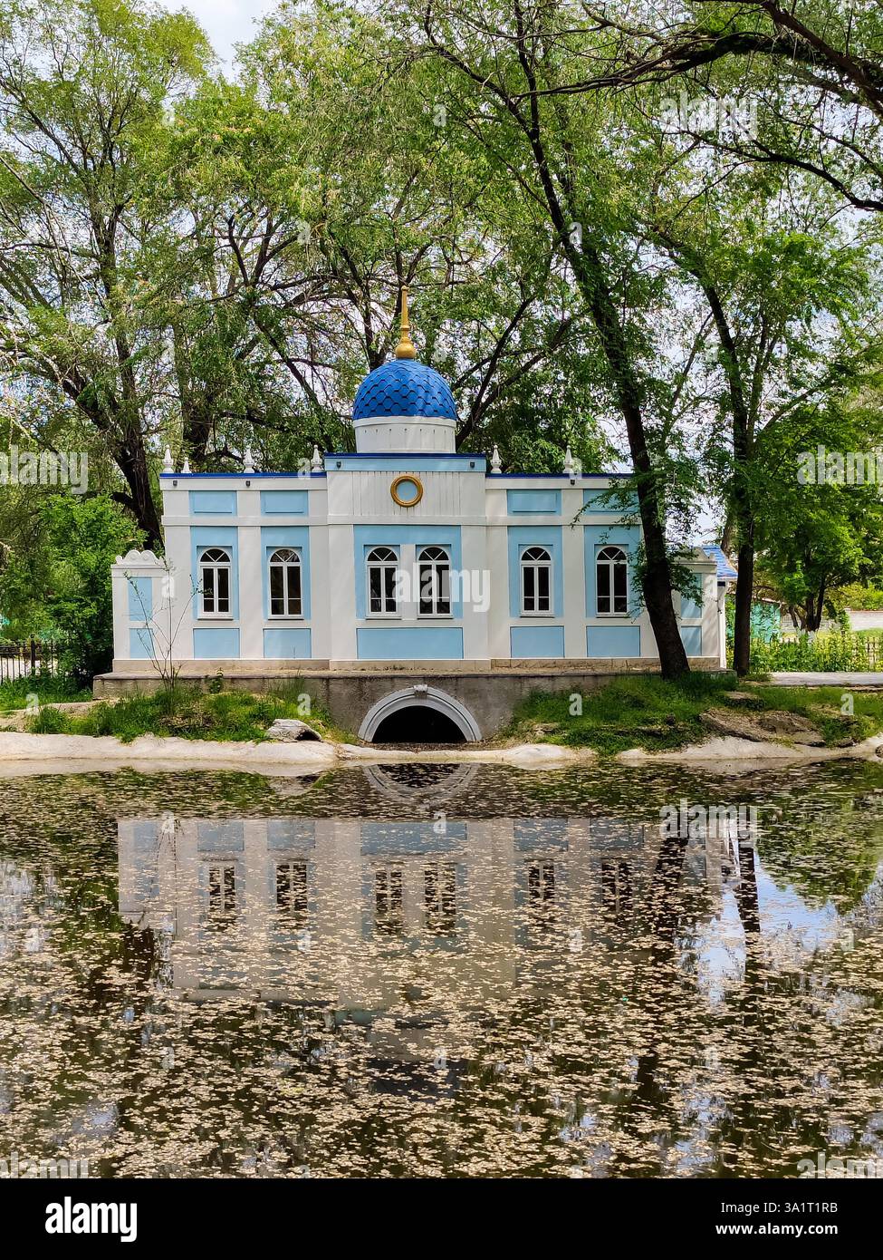 View of old building with turret, located near pond. Ancient historical ...