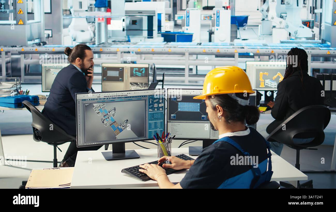 Photovoltaics factory engineer using CAD software, planning work on ...