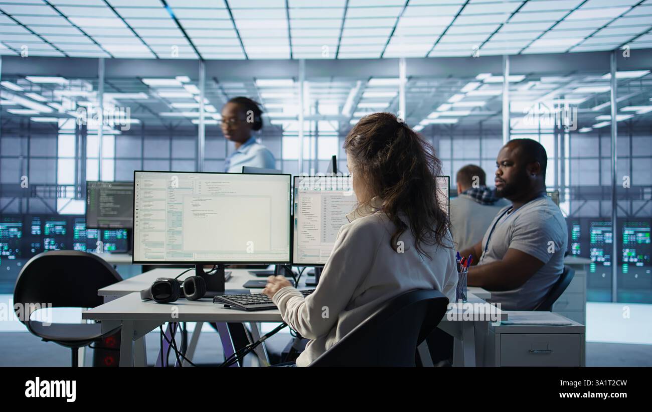System admin working in diverse computer network security data center ...