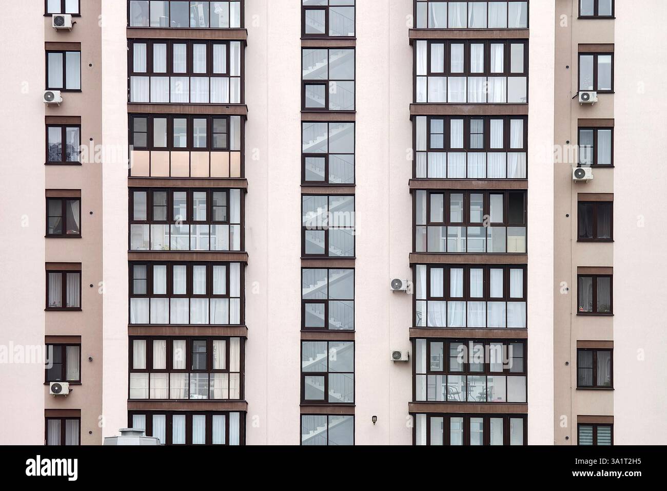 The facade of a multi-storey residential building. Many windows ...