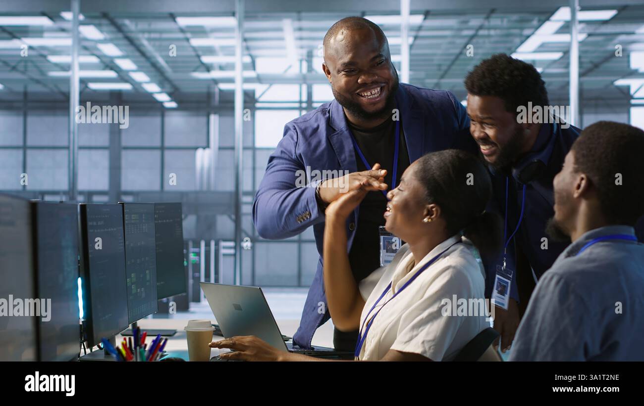 Data center coworkers laughing, having fun while maintaining company ...