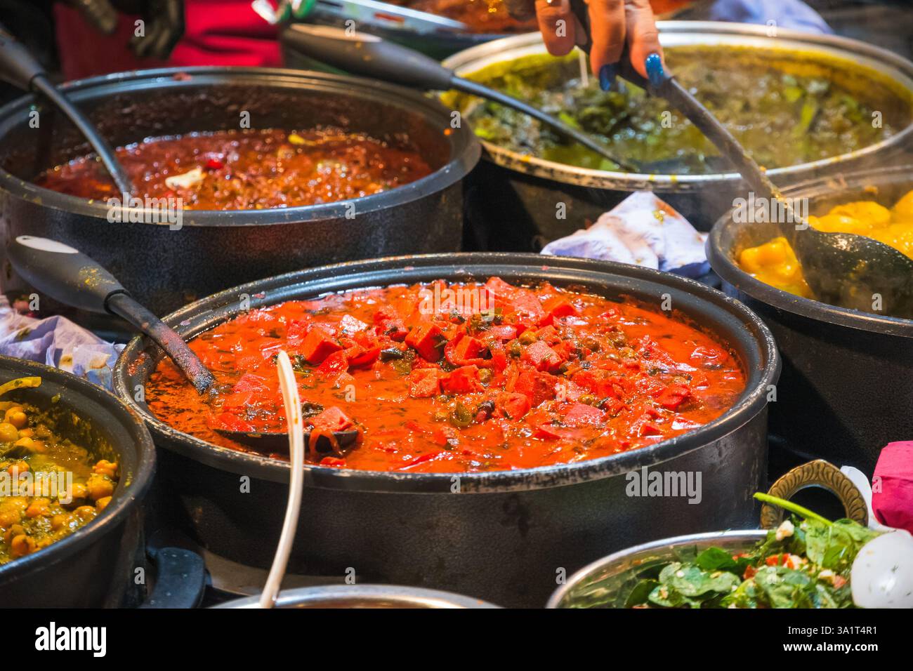 A variety of curries hot food on display at Brick Lane Market in London ...