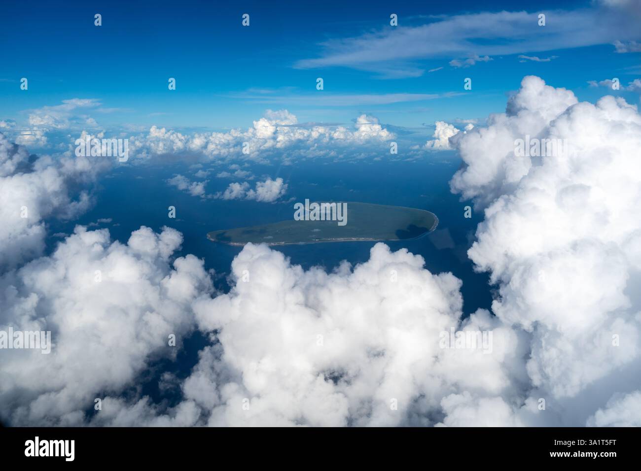 Makatea Island emerges from the vast Pacific Ocean, partially hidden by ...