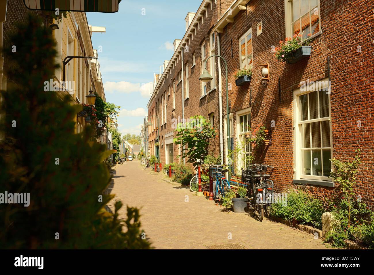 Picturesque dutch street with brick houses Stock Photo - Alamy