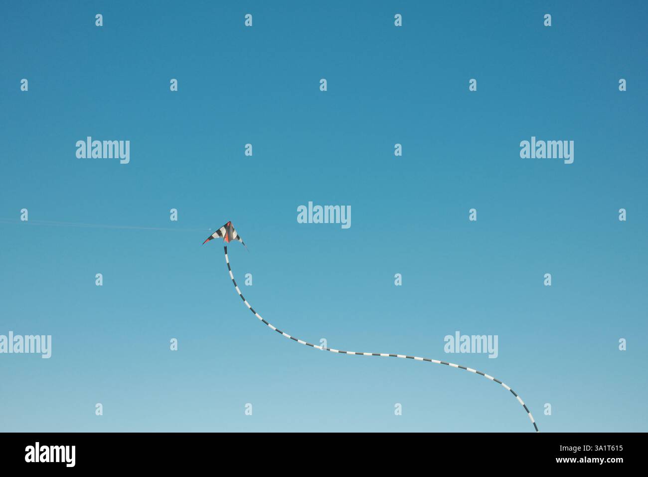 Kite flying in the clear blue sky on a windy day Stock Photo - Alamy