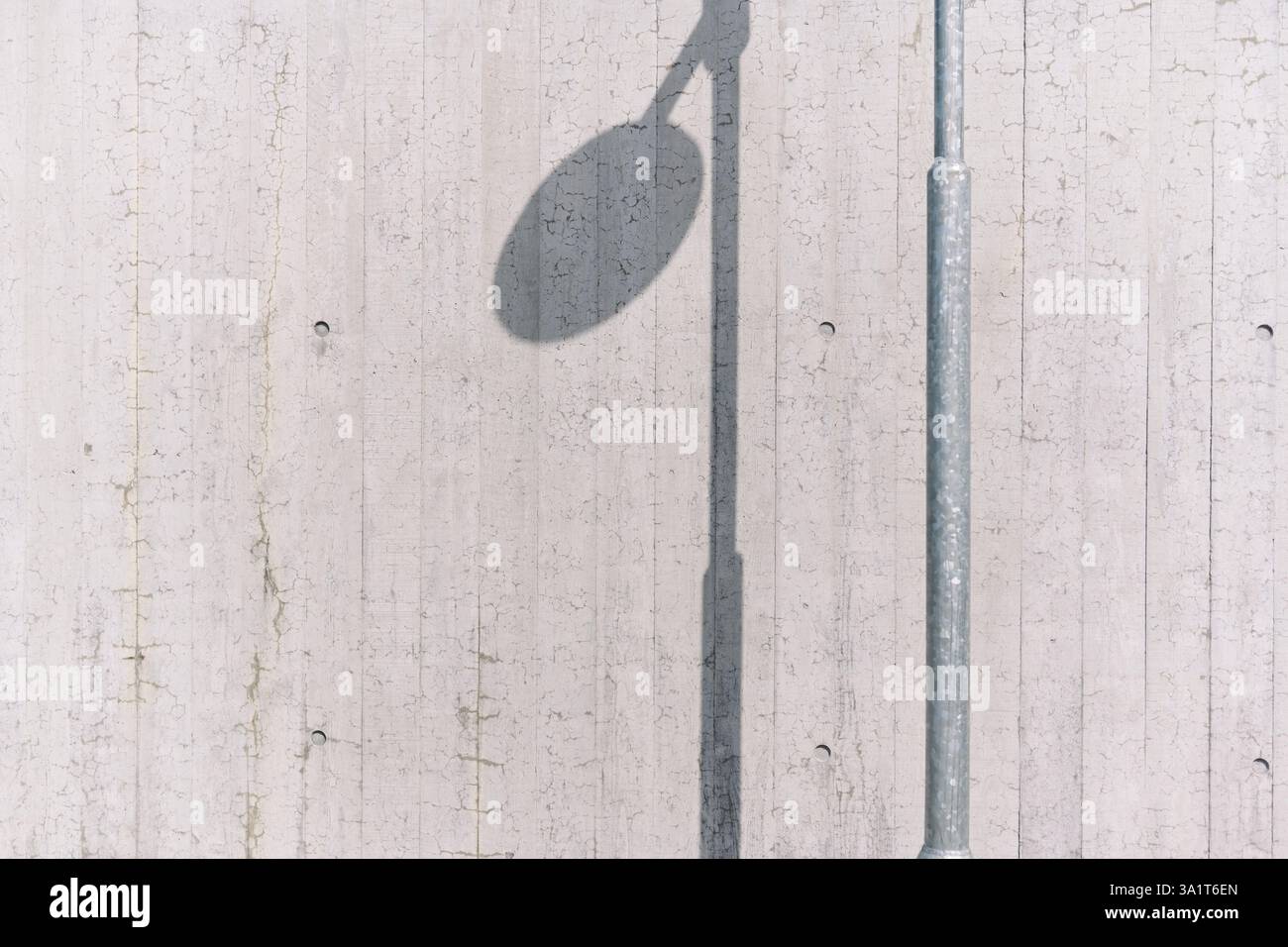 Street lamp casting shadow on concrete wall Stock Photo - Alamy