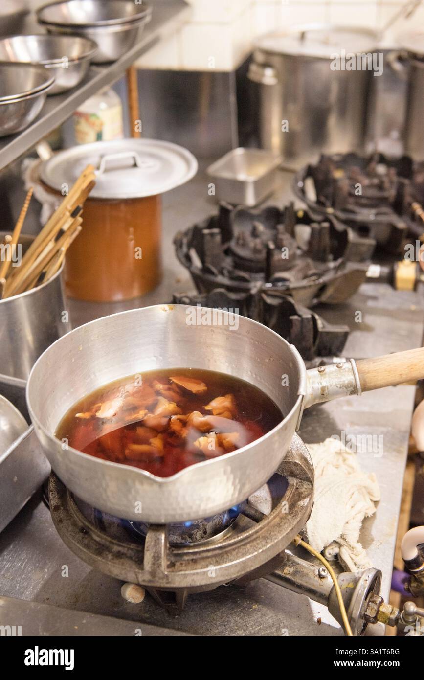Traditional Japanese broth simmering in a rustic kitchen setting Stock ...