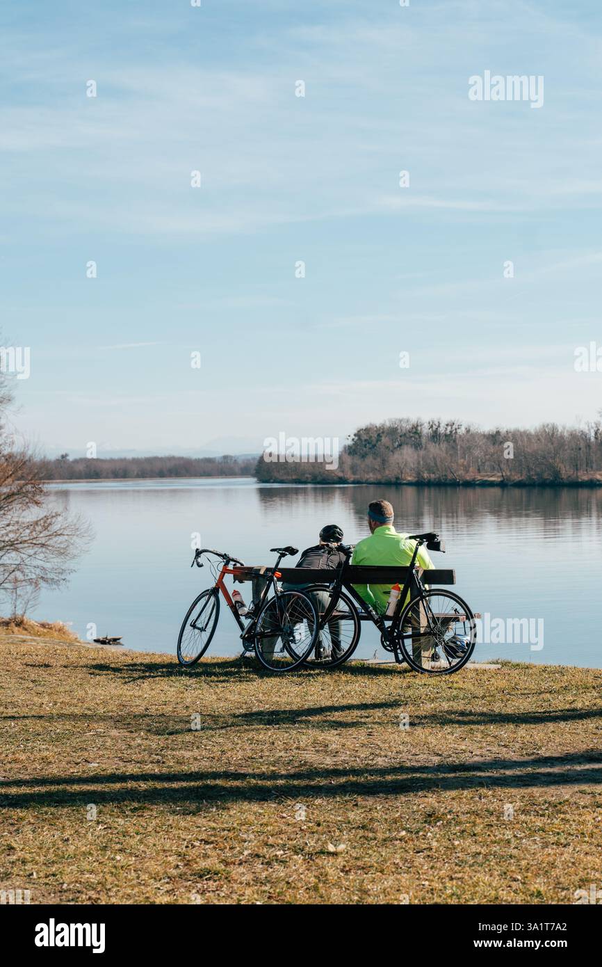 Friends enjoying a peaceful moment by the river while relaxing o Stock ...