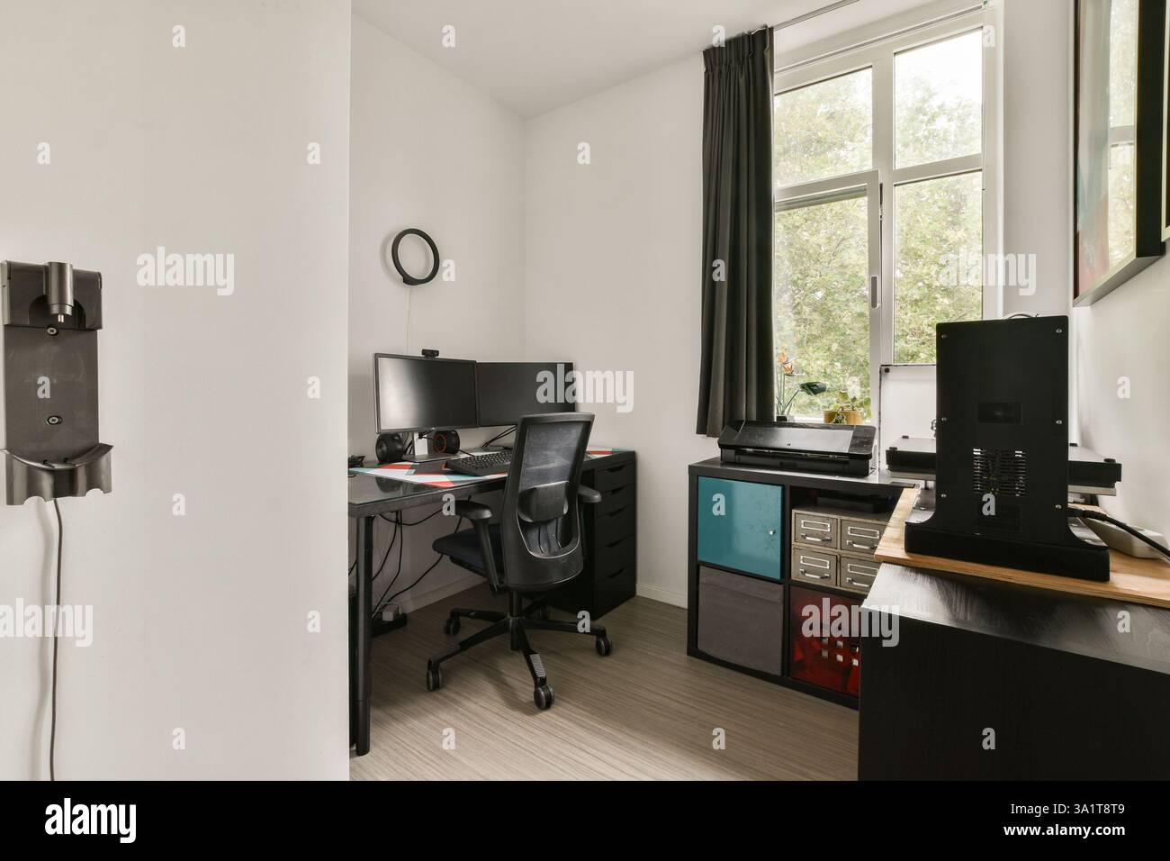 A stylish home office featuring a desk, computer setup, and natural ...