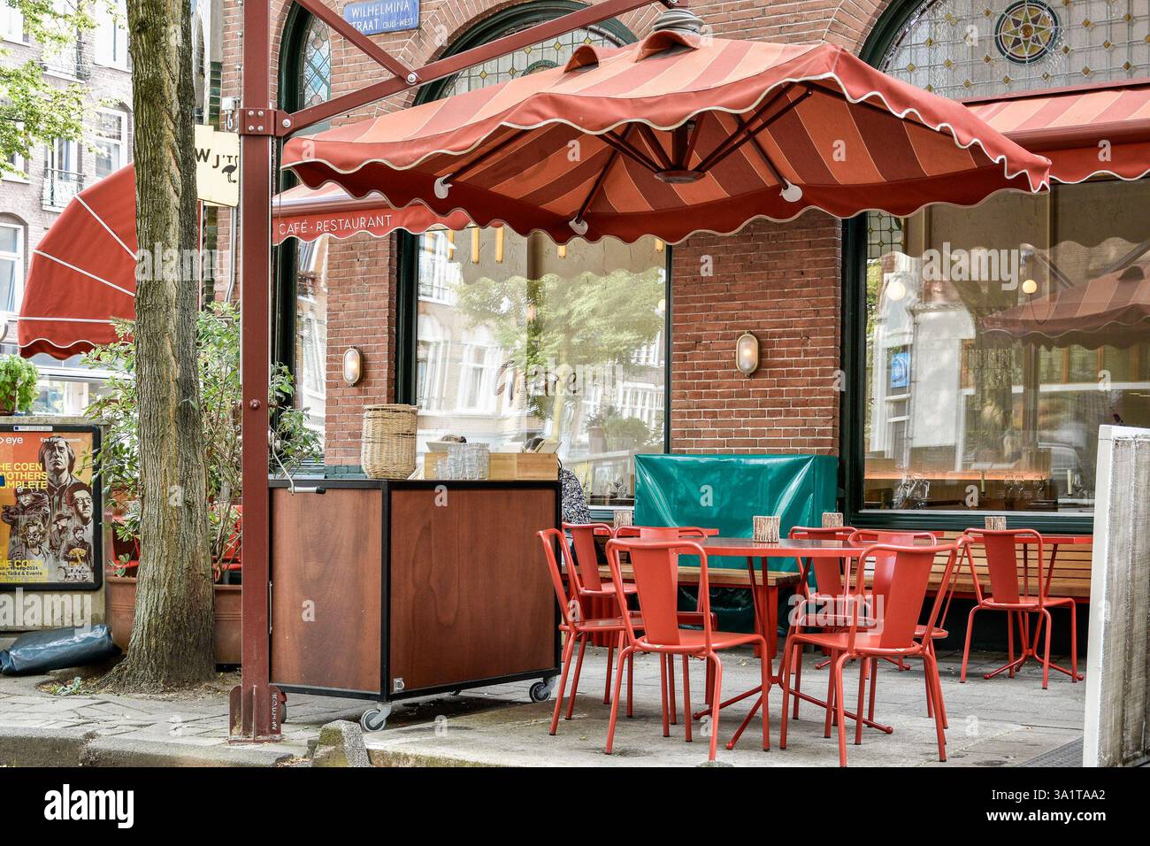 An inviting outdoor cafe showcases vibrant red umbrellas sheltering ...