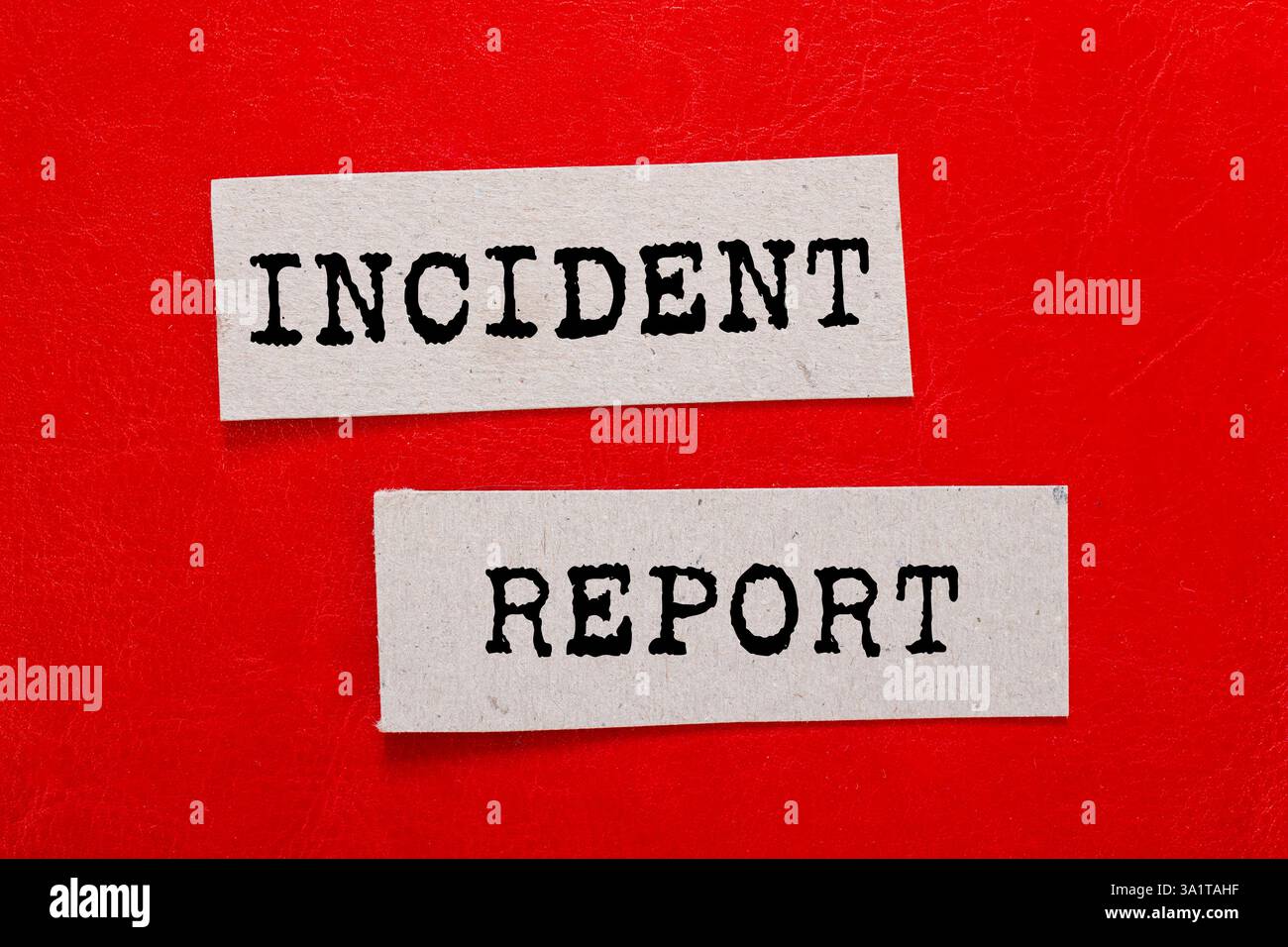 Incident report message written on paper pieces on red background ...