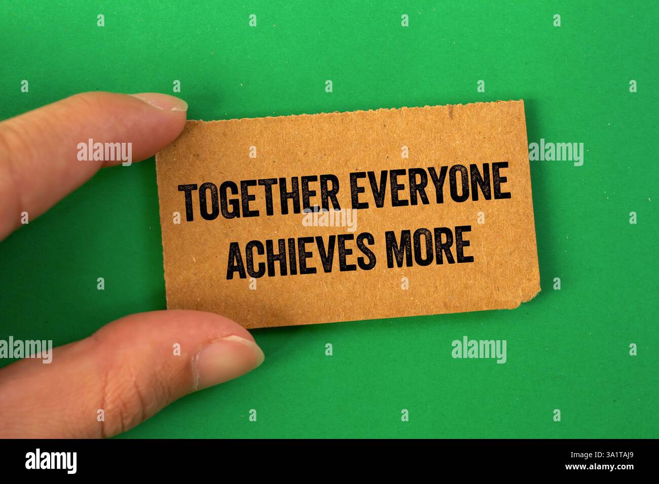 Together everyone achieves more message written on cardboard paper on ...