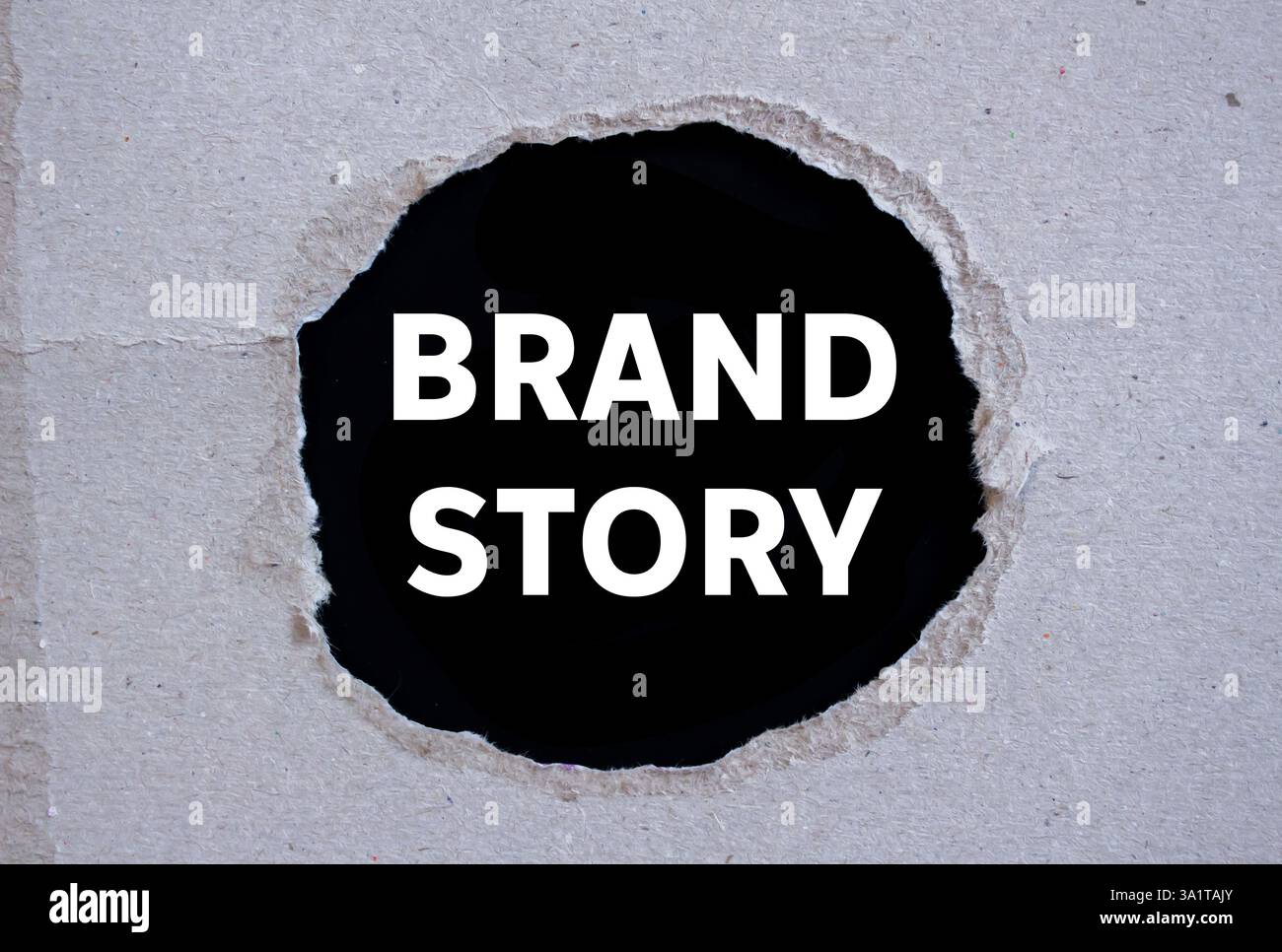 Brand story message written on ripped torn paper on black background ...