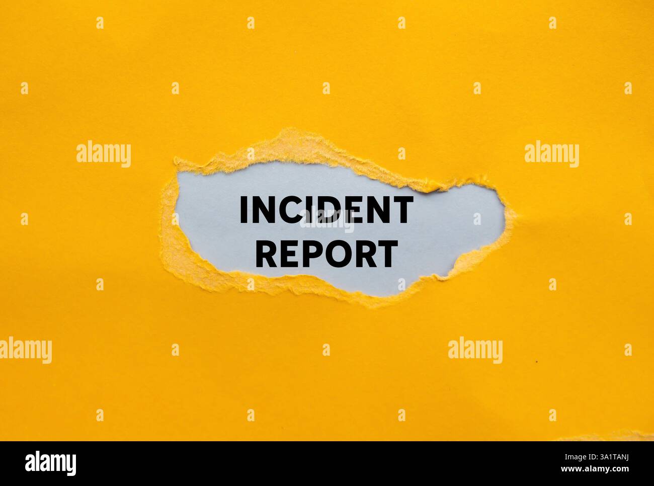 Incident report message written on ripped torn yellow paper on gray background. Conceptual ...