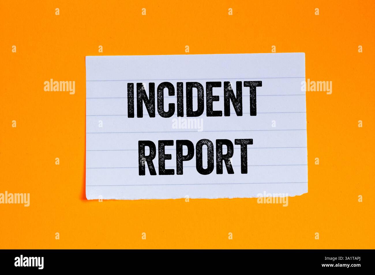 Incident report message written on ripped torn white paper piece on ...