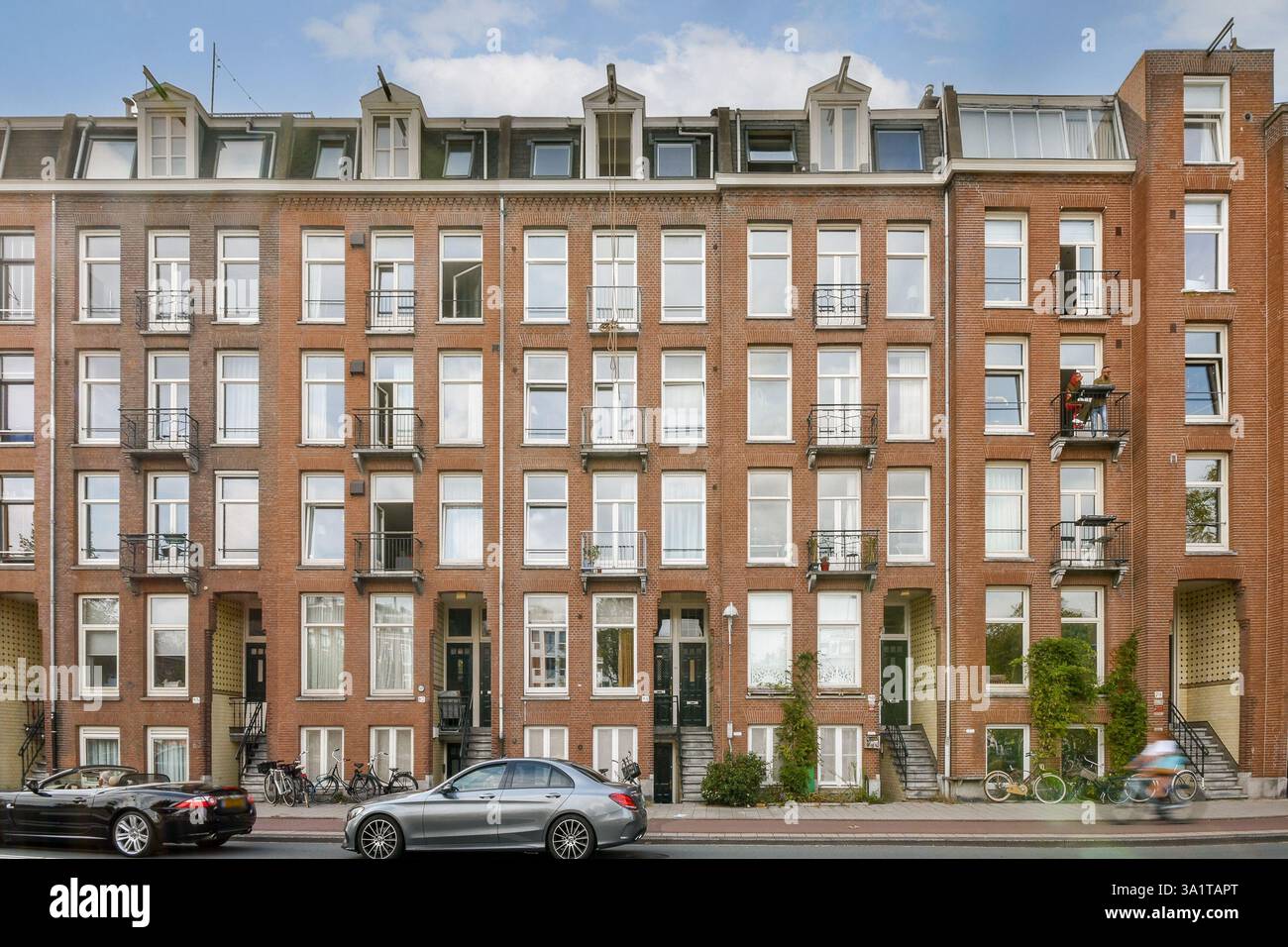 A well-maintained urban building showcasing a classic brick facade ...