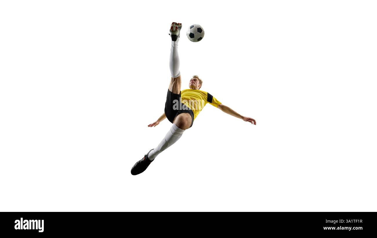Focused man, soccer player executing overhead kick, dynamically kicking ball in air and falling ...