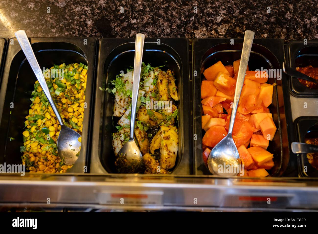 assorted fresh salads displayed for unlimited buffet dining indoors ...