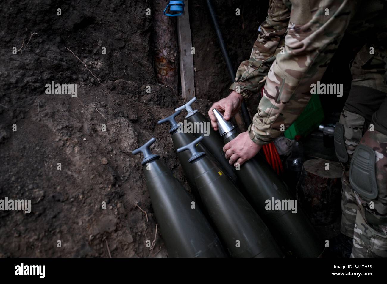 A soldier attends to 155mm shells for a 2S22 Bohdana self-propelled ...