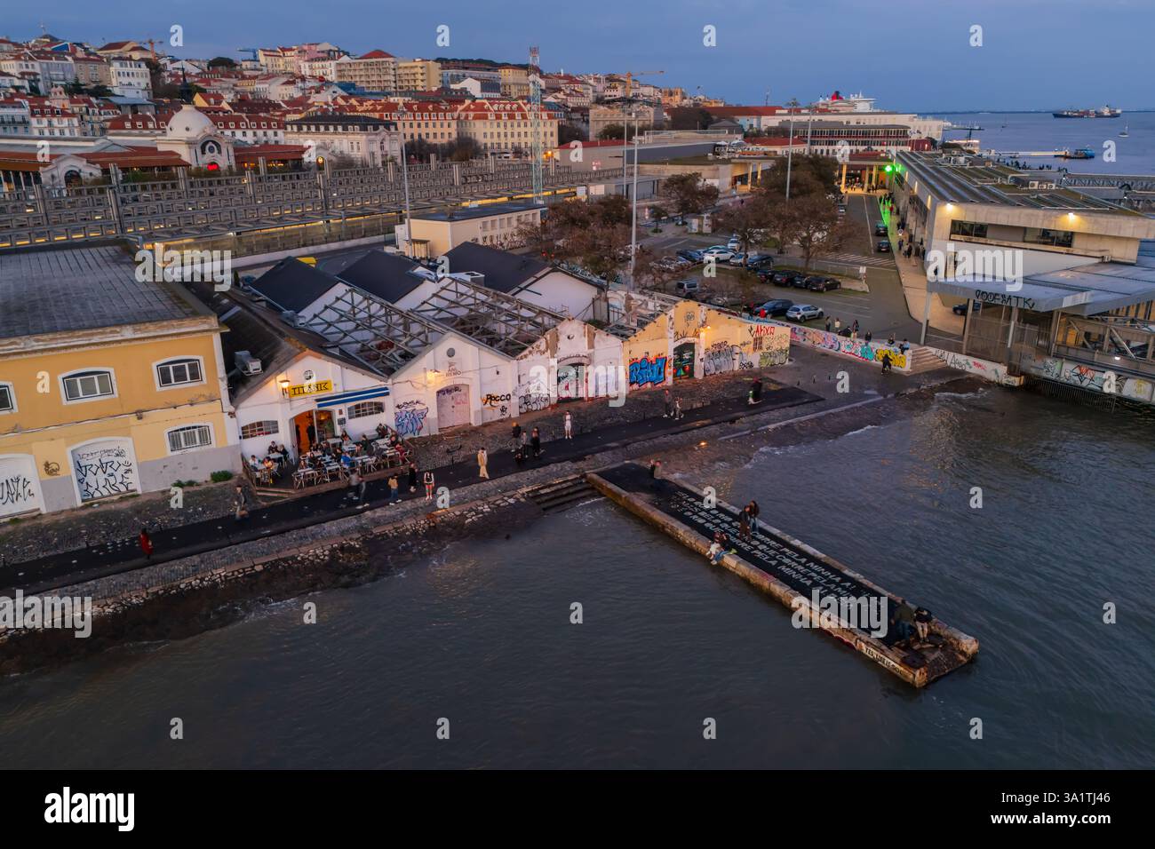 Aerial view of waterside Cais do Sodre and Titanic sur Mer at sunset, a ...